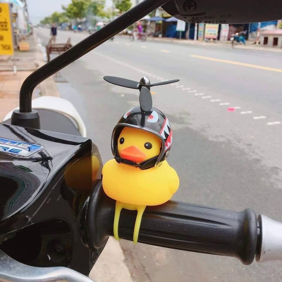Duck mounted on a motorbike wearing a helmet with flashing lights ...