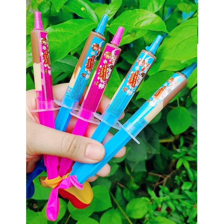 1 TUBE of syringe-shaped extruded milk chocolate candy with bubbles ...