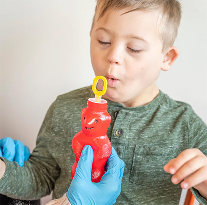 TalkTools Bubble Bear blowing bubbles promoting controlled breathing ...