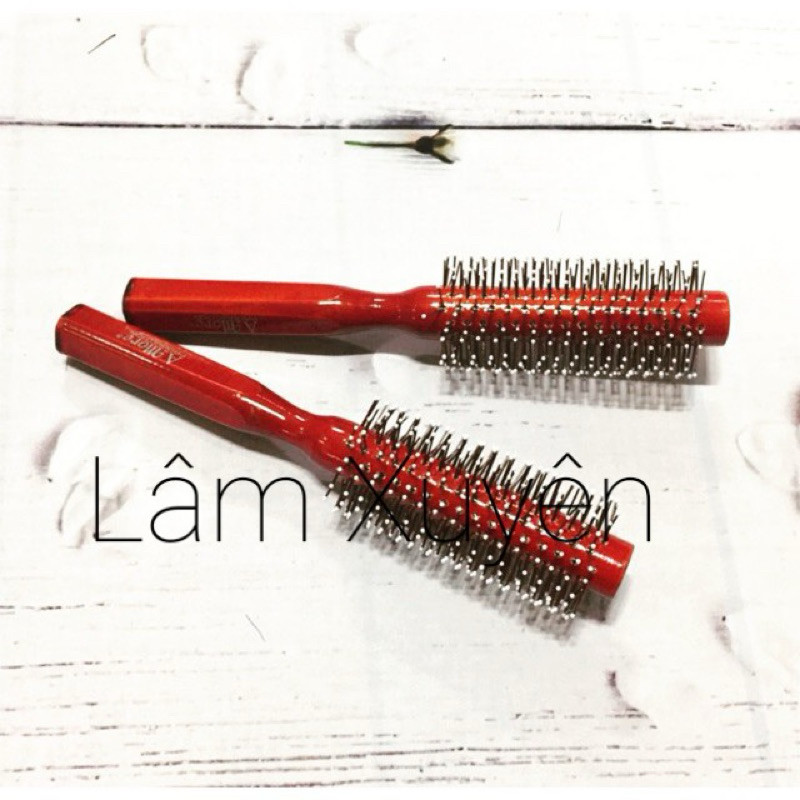 AMORE round hair drying comb with spikes wrapped on the head of a large ...
