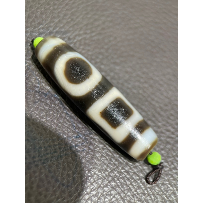 Double Tibetan Dzi with smooth, old stone, black and white color ...