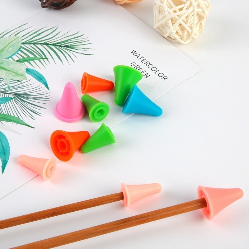 Plastic stopper covers the tip of the knitting needle to prevent wool ...